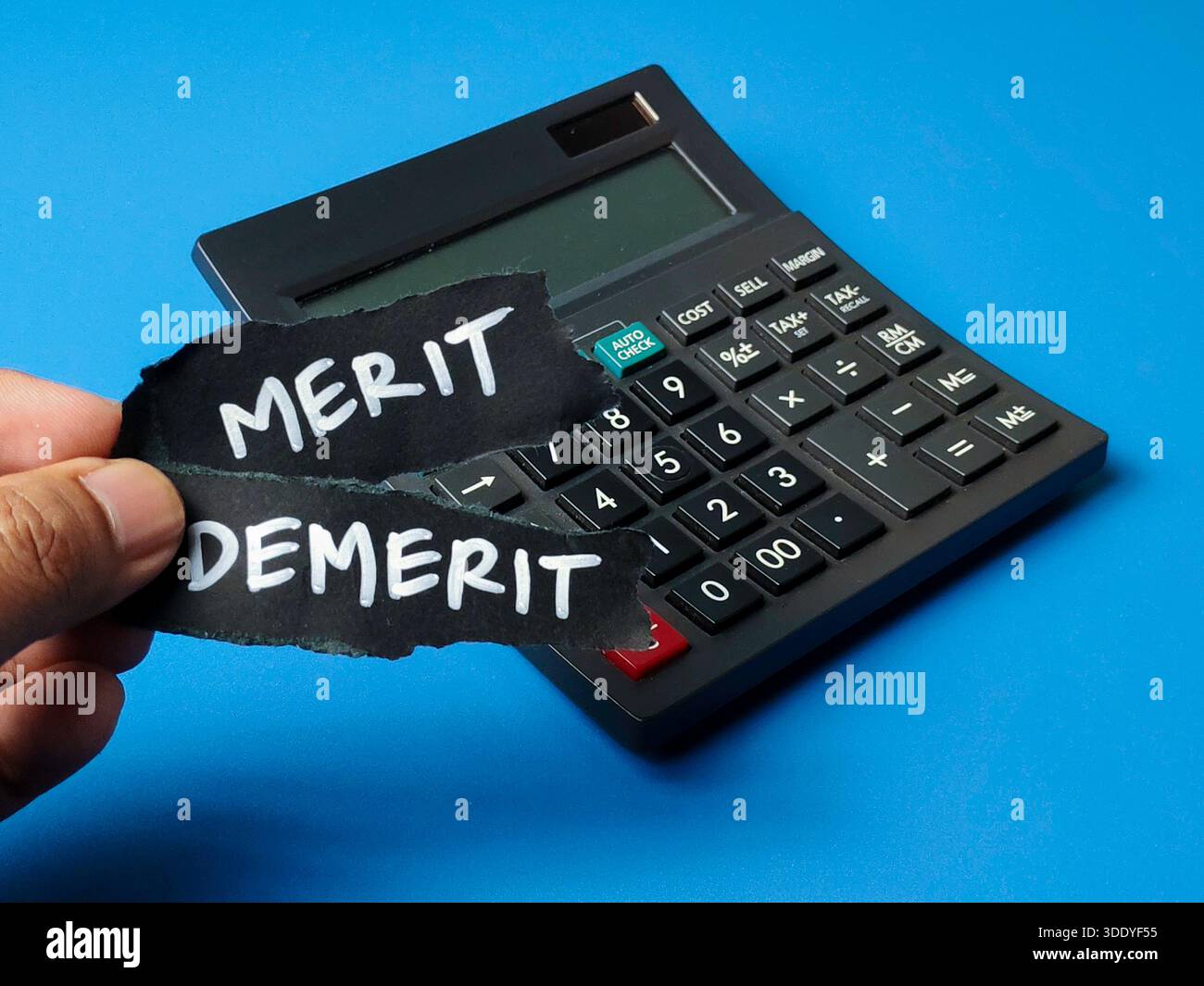 Hand Holding Merit and Demerit Signs over Digital Calculator for ...