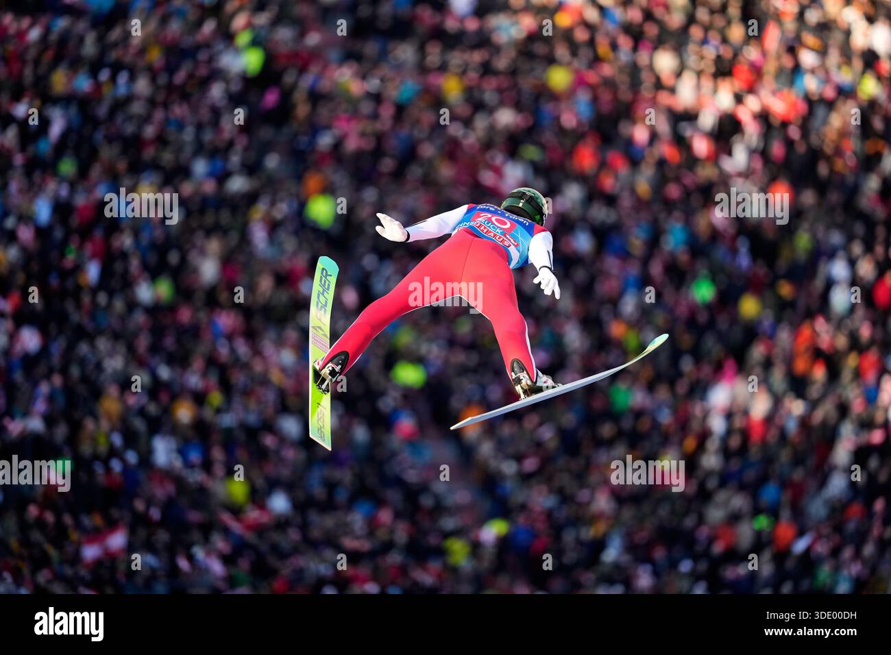 Jonas Schuster, of Austria, soars through the air during his first ...