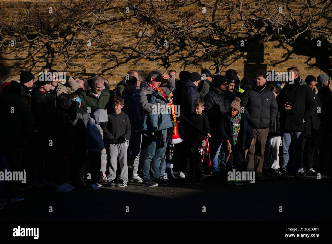 Fans wait for the teams outside the Craven Cottage stadium ahead of the ...