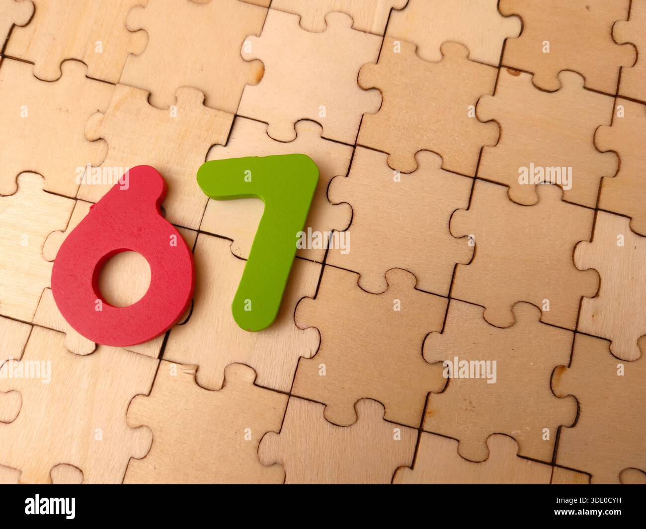 The image shows wooden number puzzle pieces, specifically the numbers 6 ...