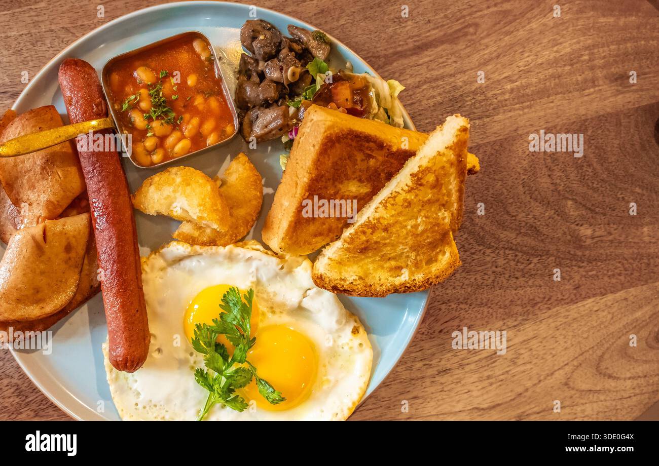 Traditional morning English breakfast with fried egg yolks, grilled ...