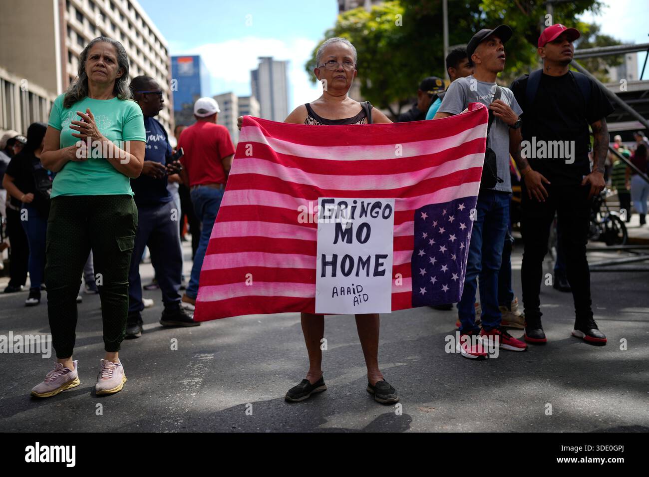 A government supporters displays a U.S. flag in Caracas, Venezuela ...