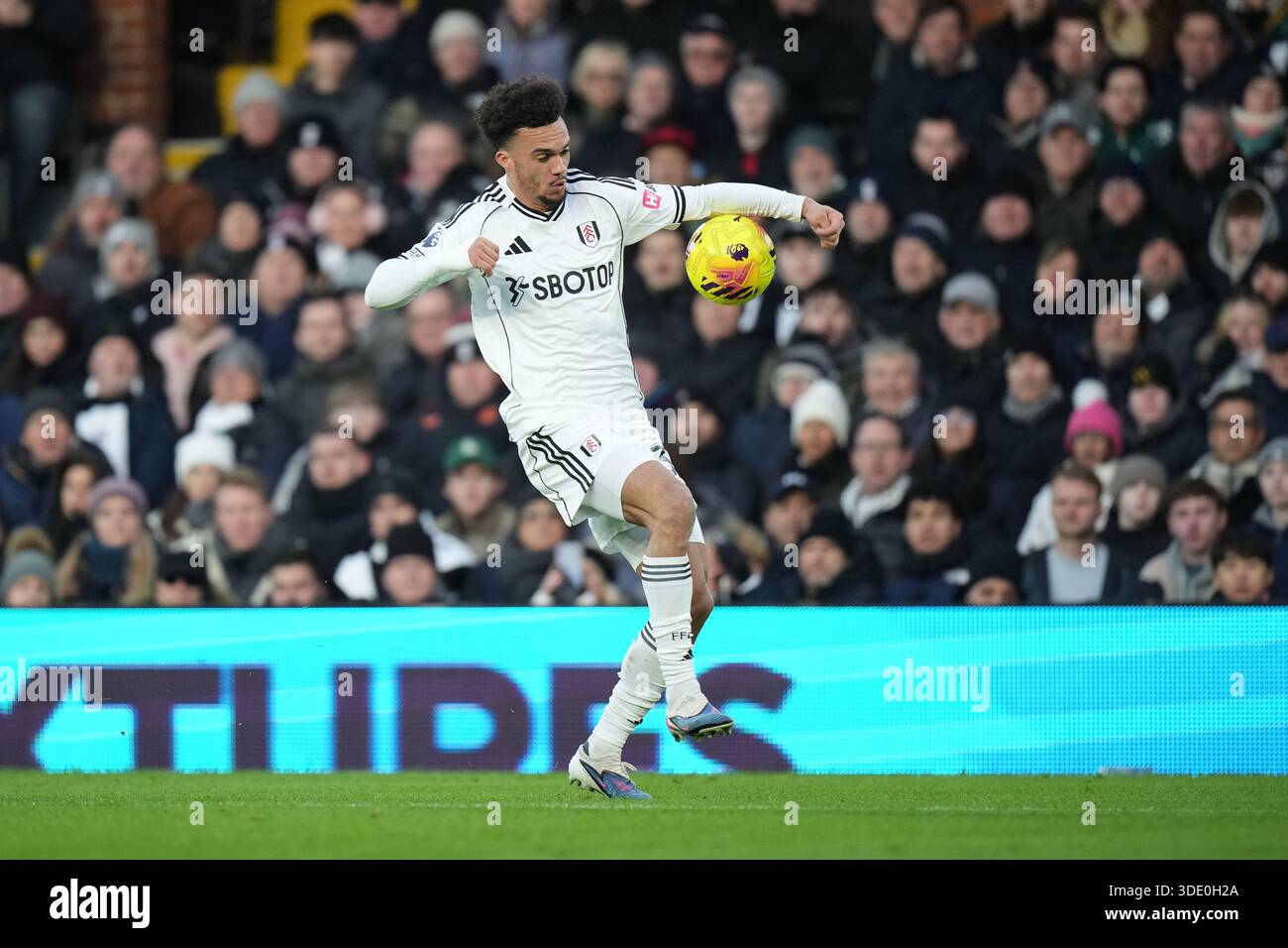 Fulham's Antonee Robinson commits a handball during the English Premier ...