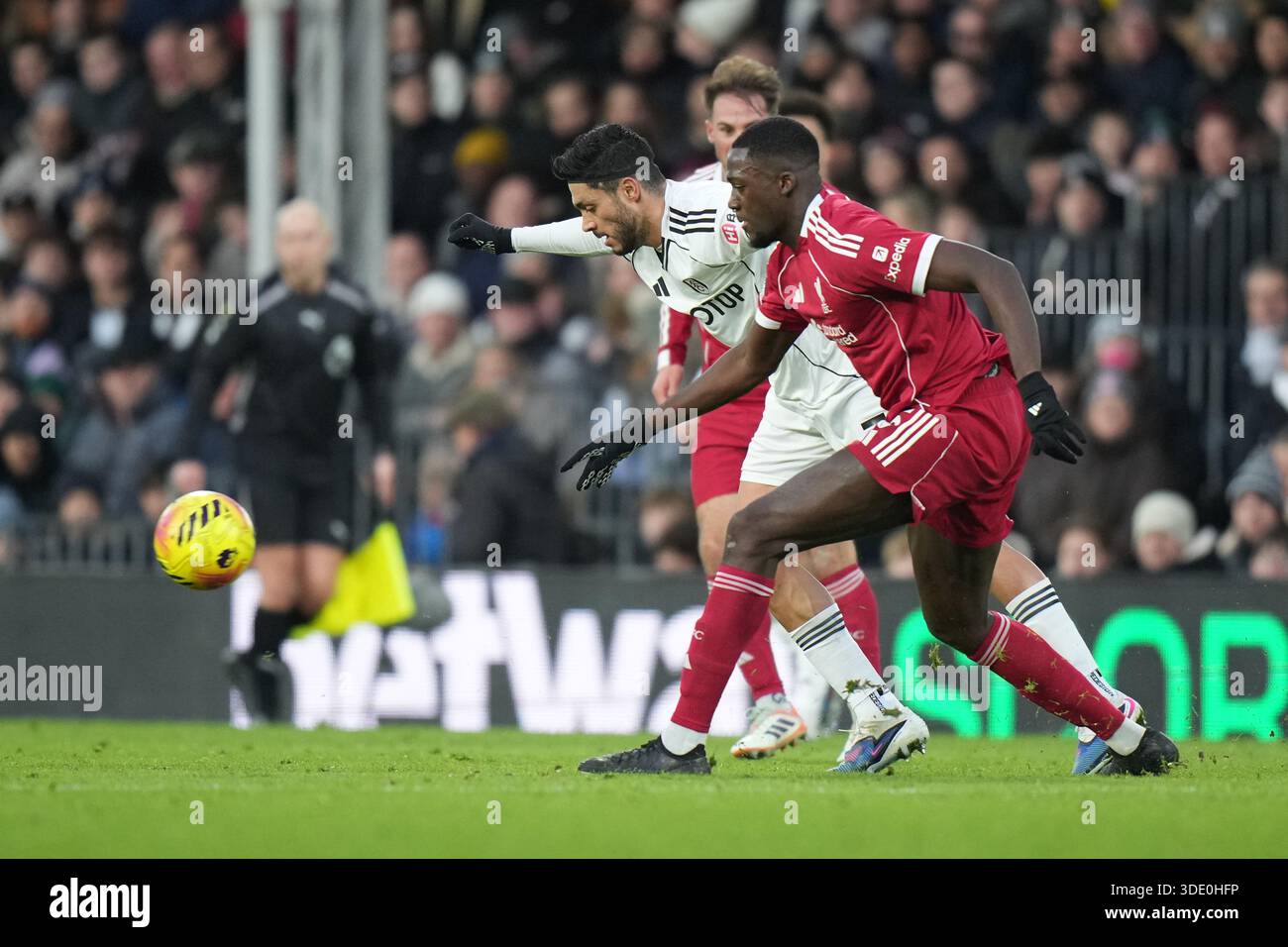 Fulham's Raul Jimenez challenges for the ball with Liverpool's Ibrahima ...