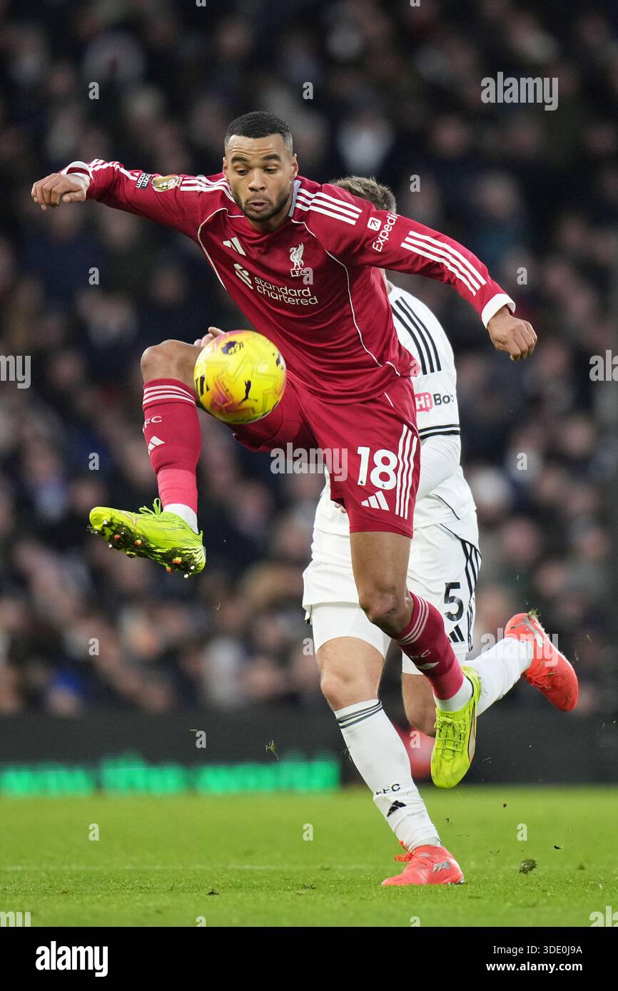 Liverpool's Cody Gakpo controls the ball next to Fulham's Joachim ...