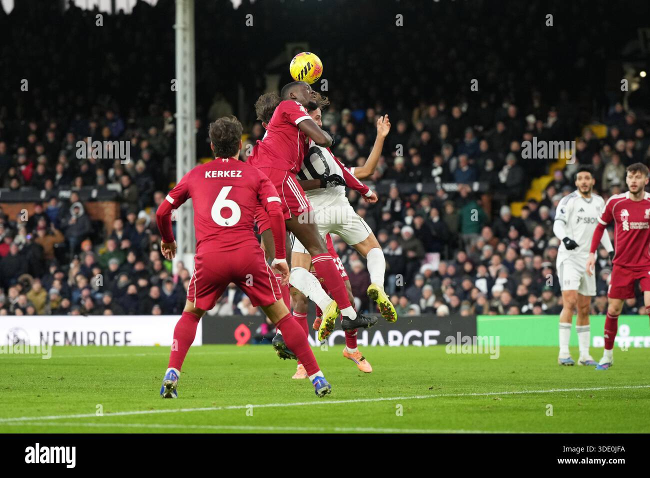 Liverpool's Ibrahima Konate jumps for a header with Fulham's Tom ...