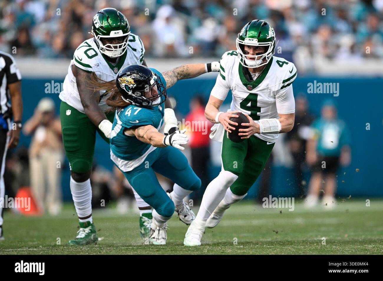 New York Jets quarterback Brady Cook (4) scrambles past Jacksonville ...