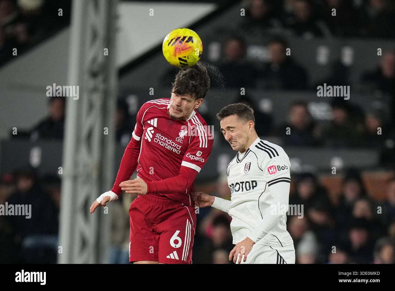 Liverpool's Milos Kerkez, left, jumps for a header with Fulham's ...