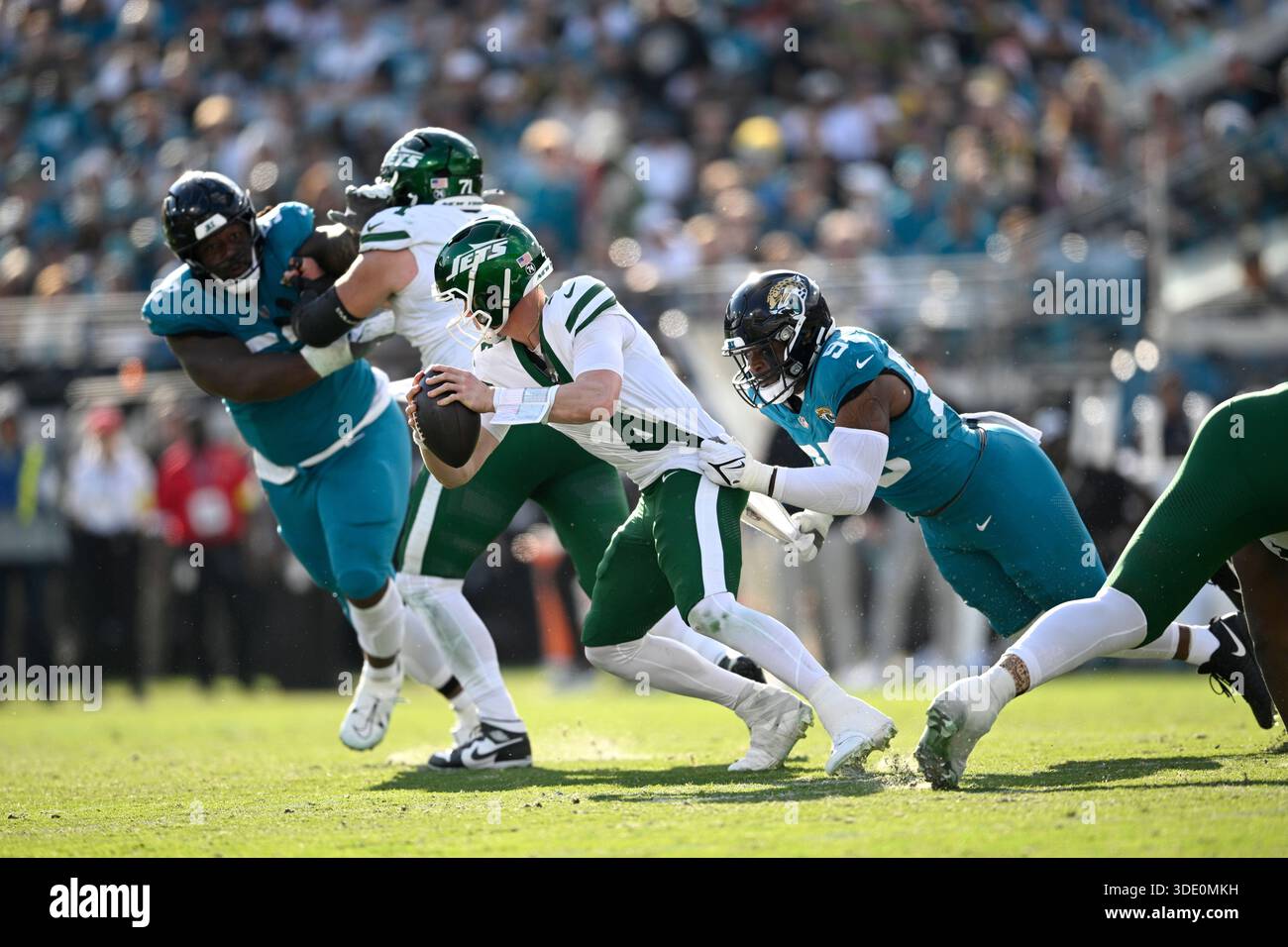 New York Jets quarterback Brady Cook (4) is pressured by Jacksonville ...