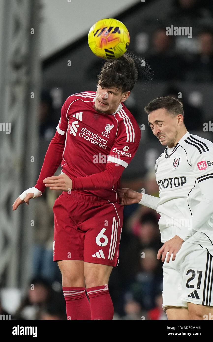 Liverpool's Milos Kerkez, left, jumps for a header with Fulham's ...