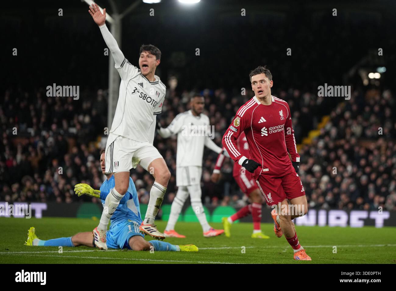 Liverpool's Florian Wirtz looks at the line referee after scoring his ...