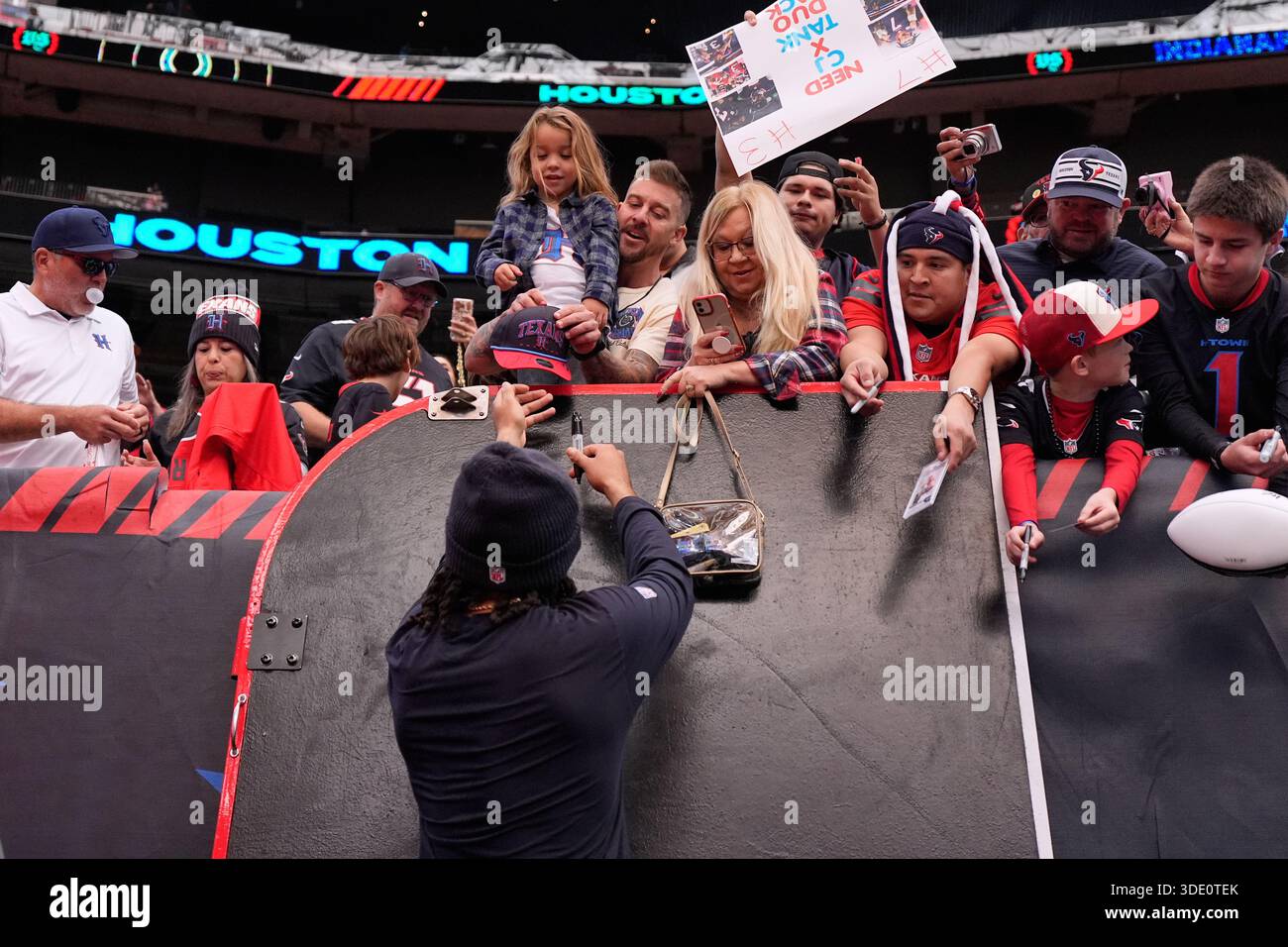 Houston Texans quarterback C.J. Stroud, left, signs autographs before ...
