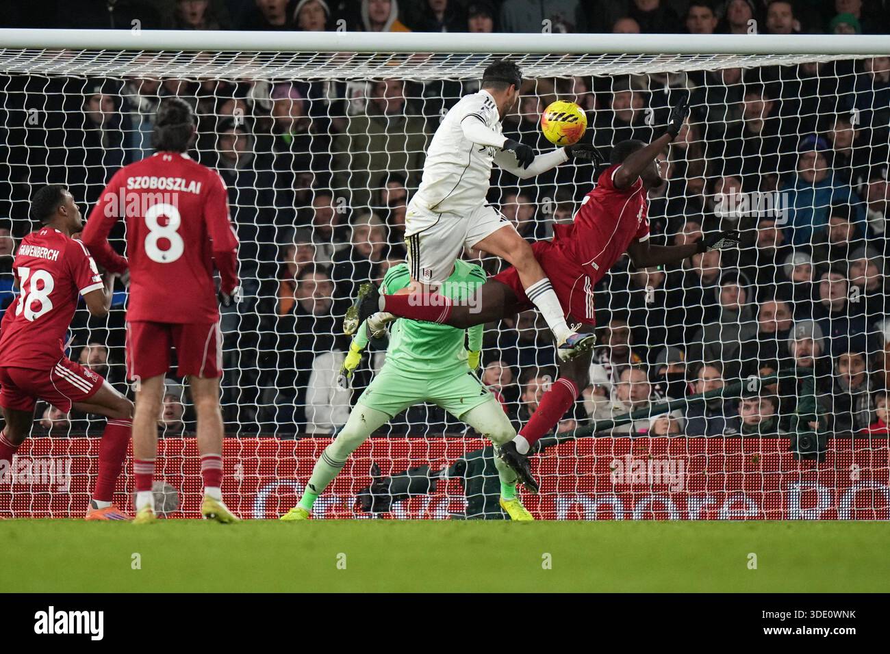 Fulham's Raul Jimenez heads the ball next to Liverpool's Ibrahima ...
