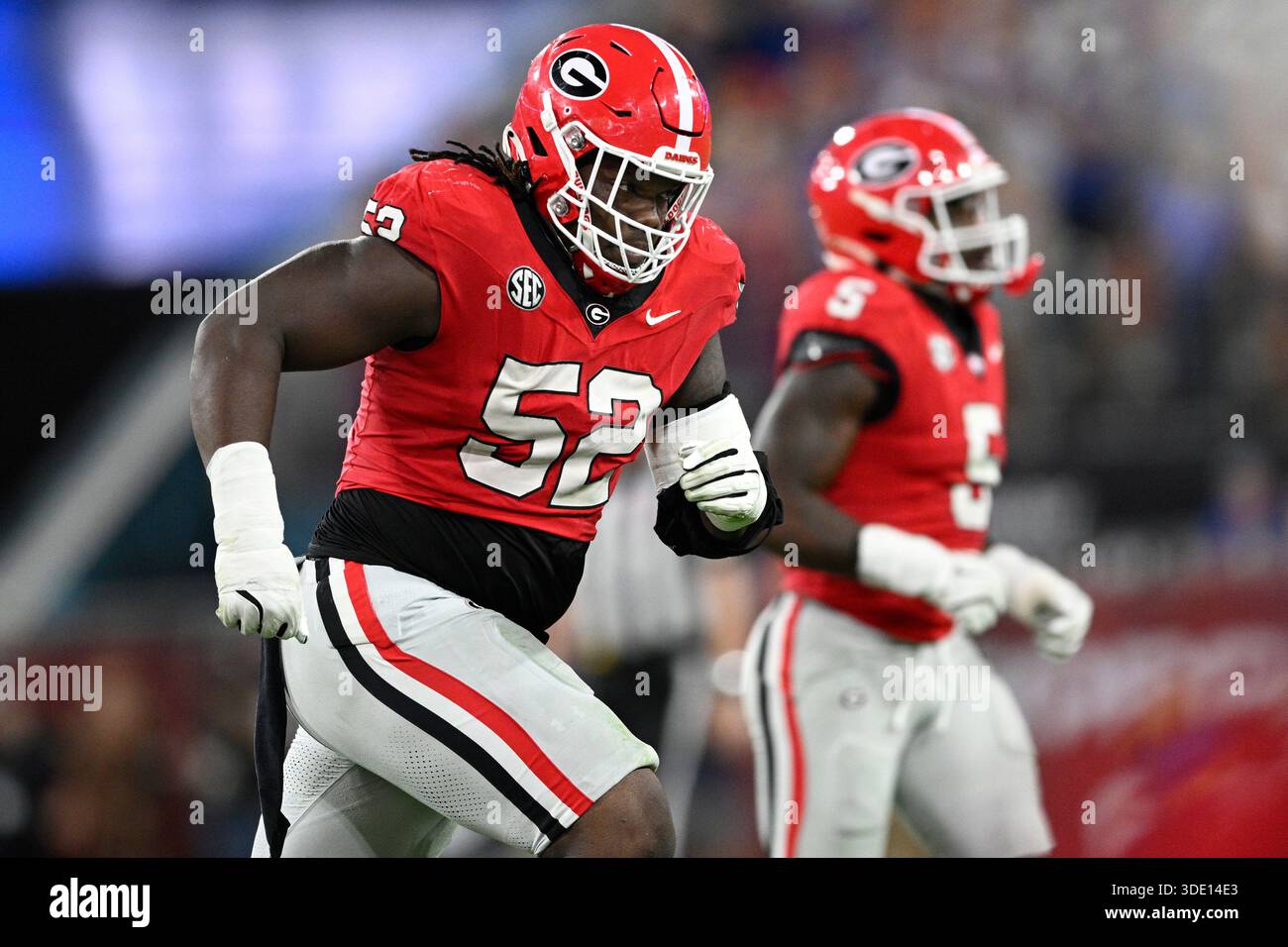 FILE - Georgia defensive lineman Christen Miller (52) heads to the ...