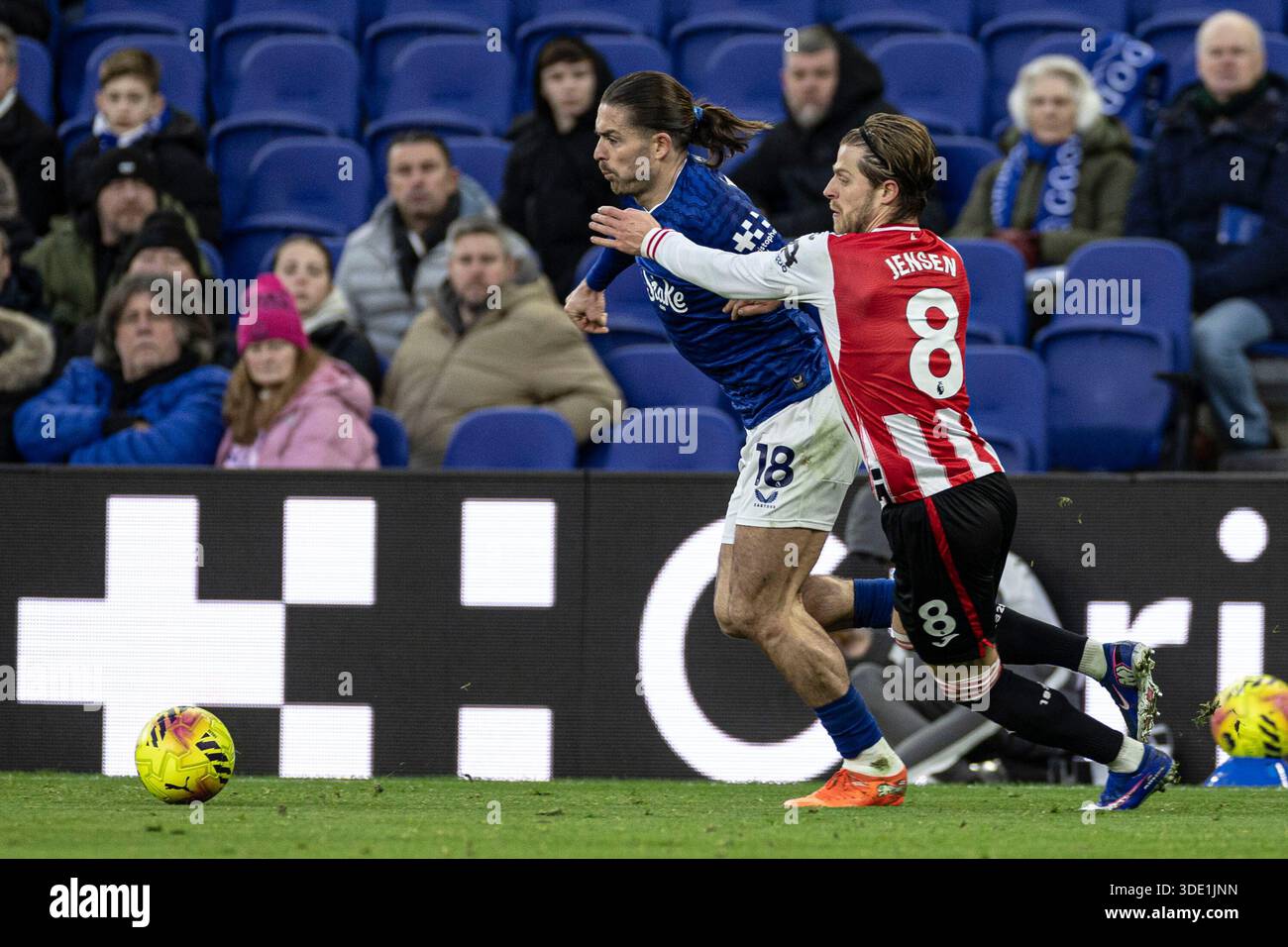 Jack Grealish #18 of Everton F.C. challenged by Mathias Jensen #8 of ...