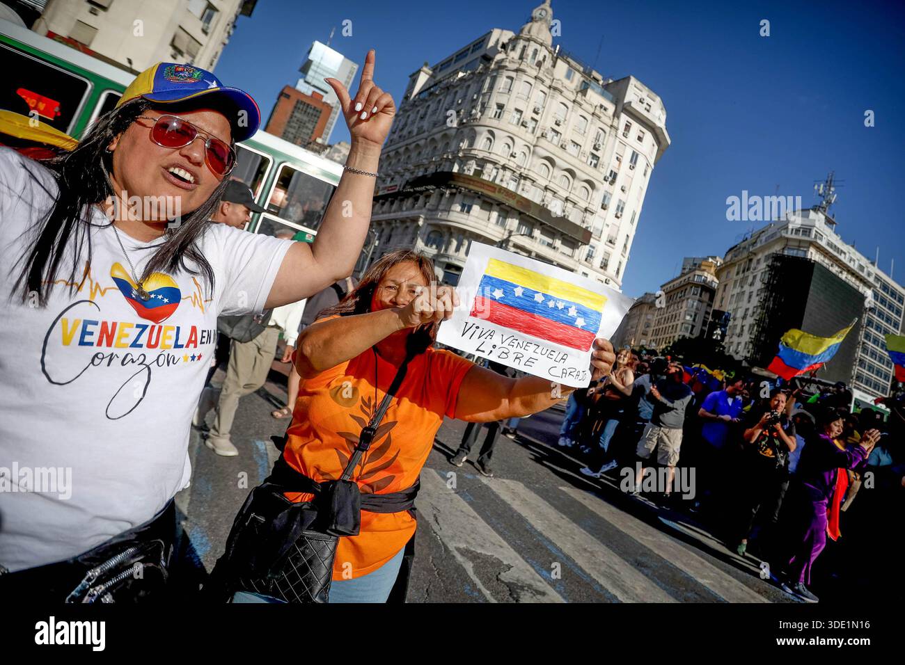 A woman holds a poster of Free Venezuela during the celebrations for ...