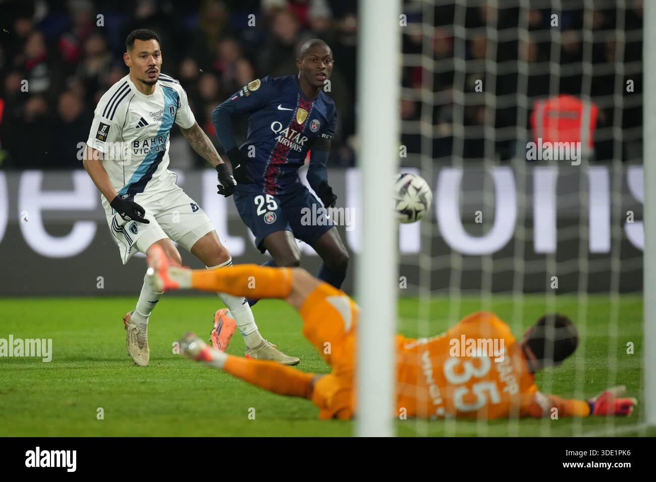 Paris FC's goalkeeper Kevin Trapp saves a shot by PSG's Nuno Mendes ...