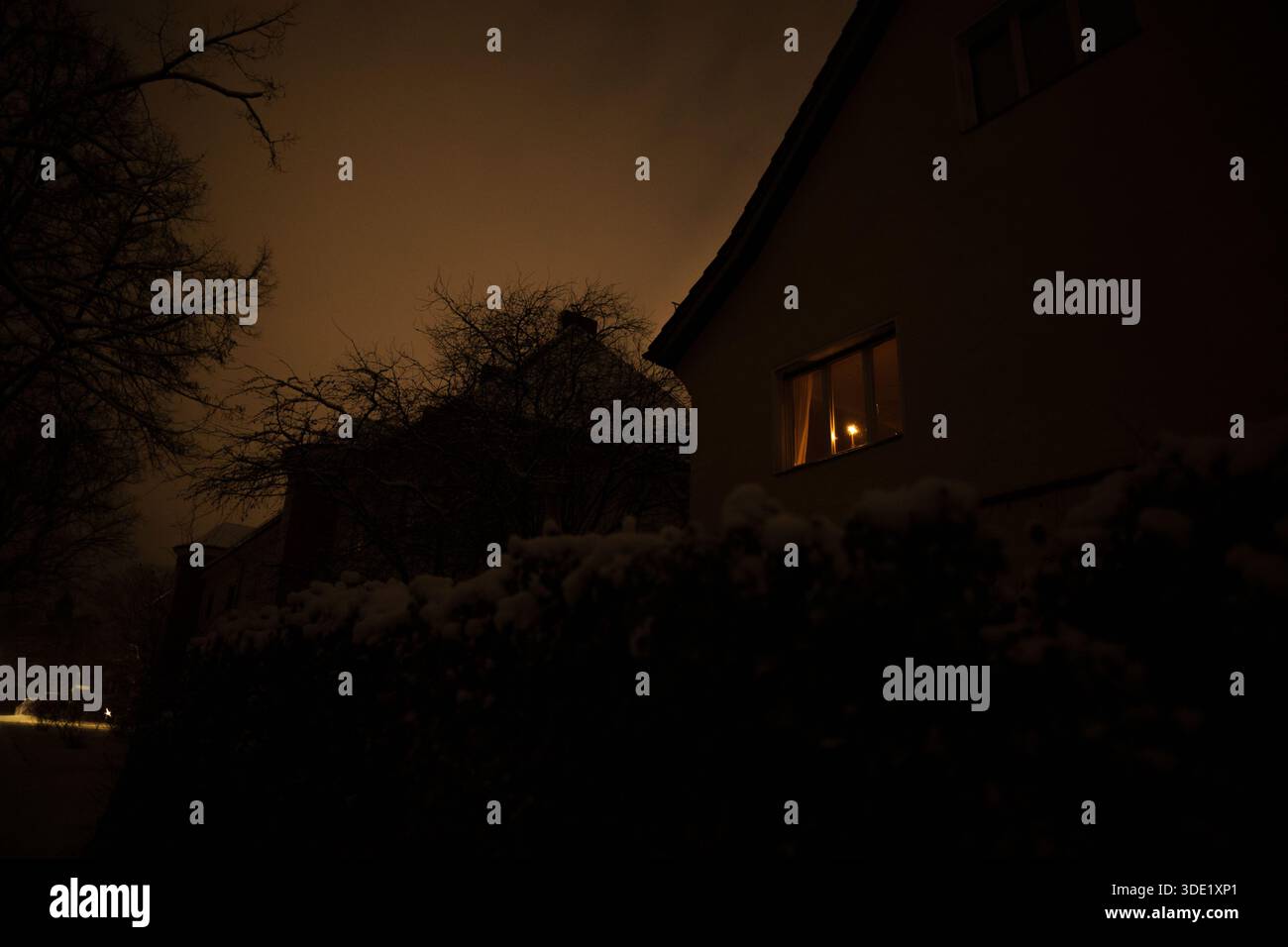 04 January 2026, Berlin: A candle lights up in an apartment building ...