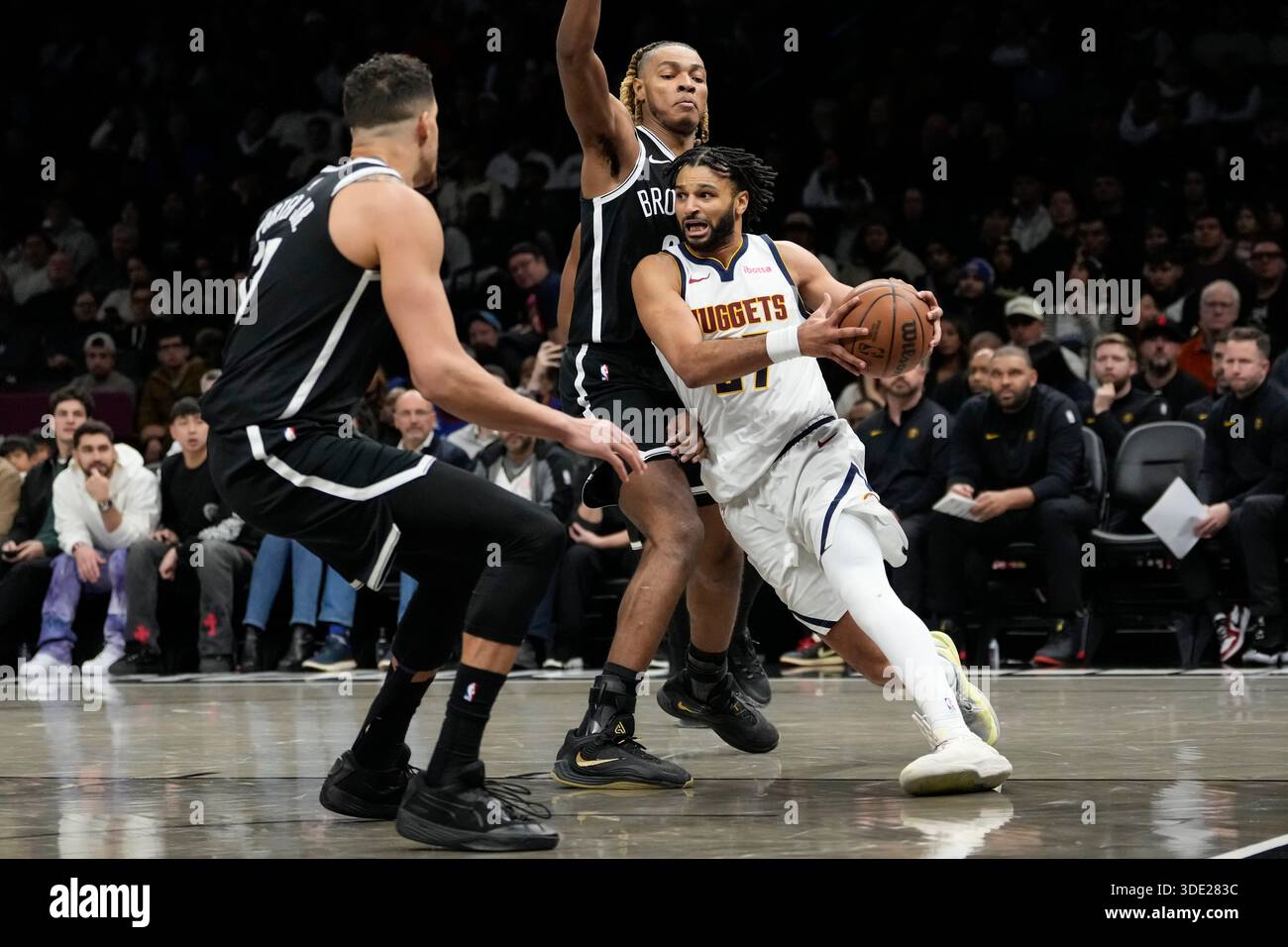 Denver Nuggets guard Jamal Murray, right, drives past Brooklyn Nets ...