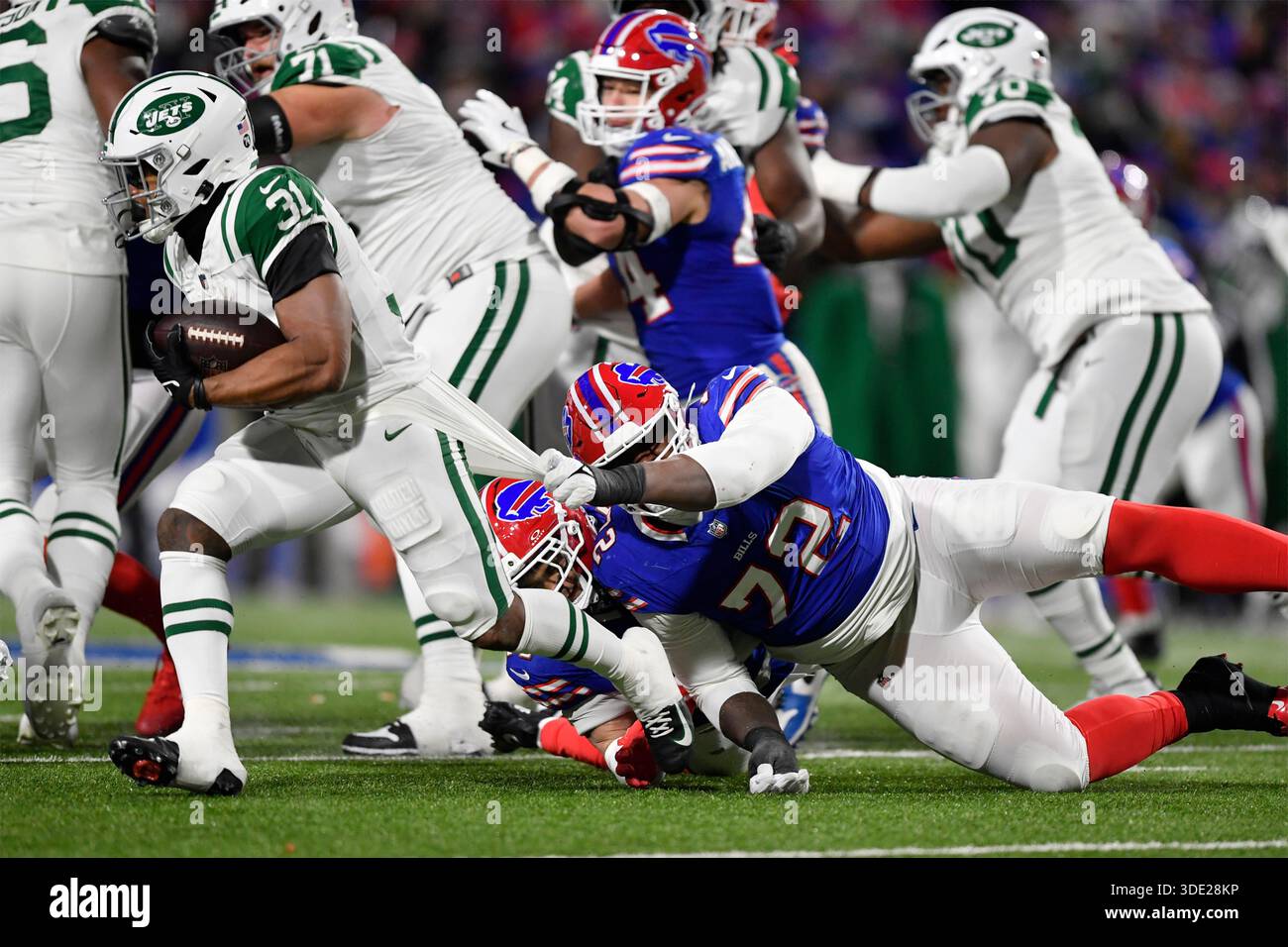 Buffalo Bills defensive tackle Phidarian Mathis (72) hangs onto Buffalo ...