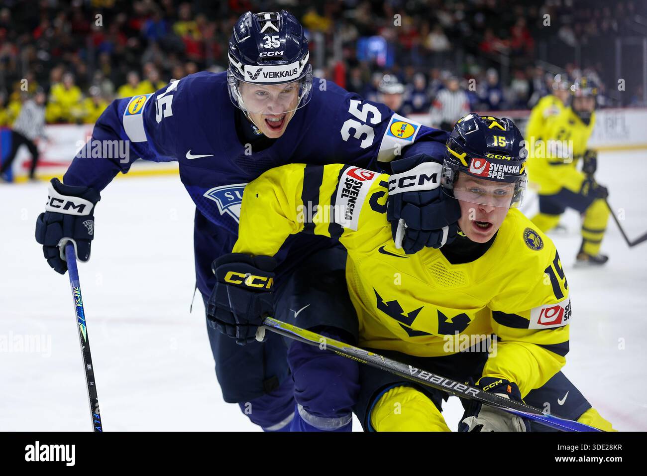 Finland forward Atte Joki, left, and Sweden forward Ivar Stenberg ...