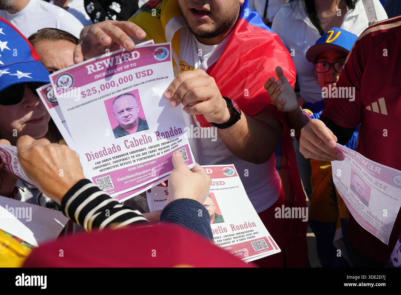 Reward posters are passed out at a gathering celebrating the deposing ...