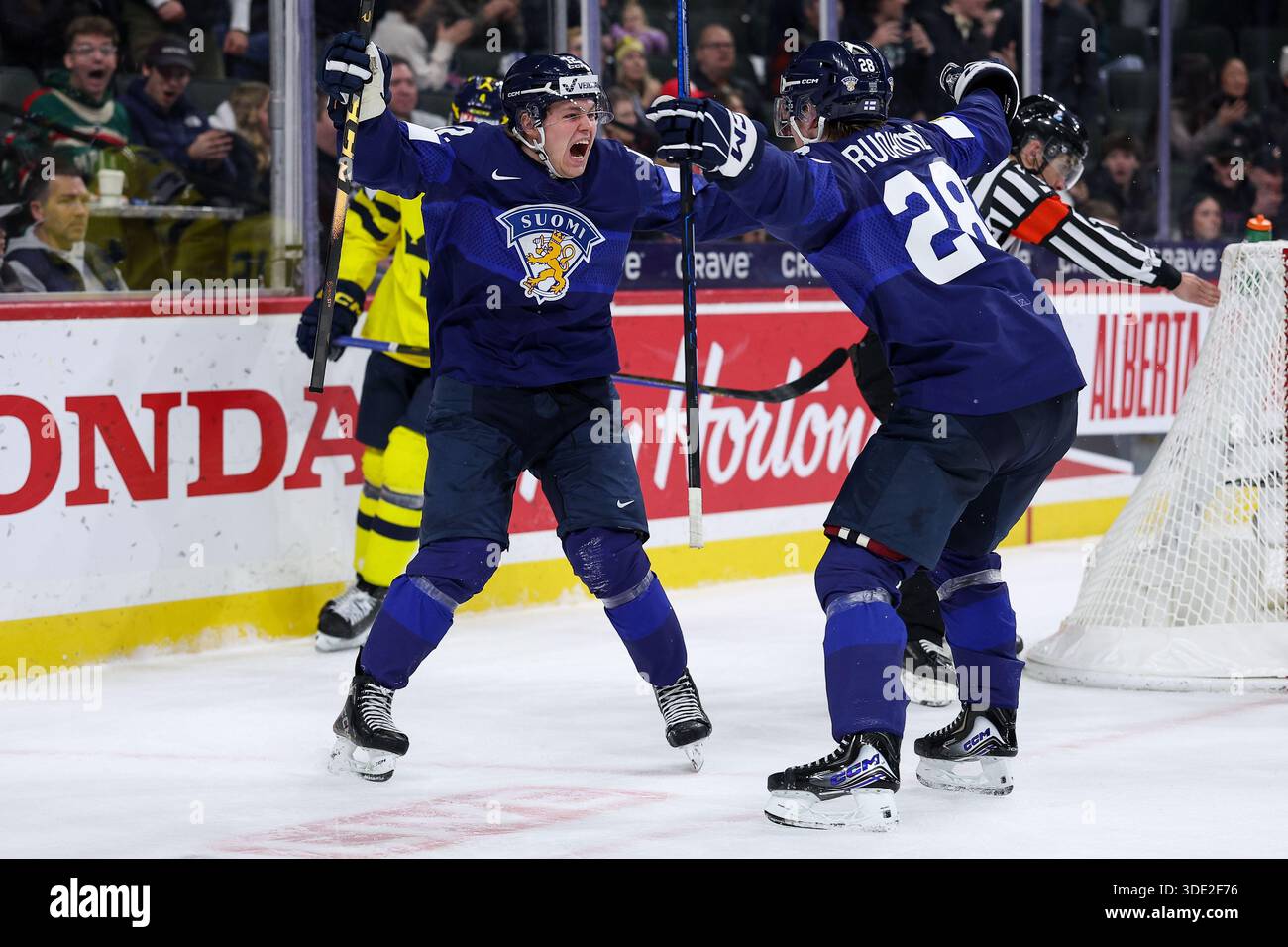 Finland forward Joona Saarelainen. left, celebrates his goal against ...