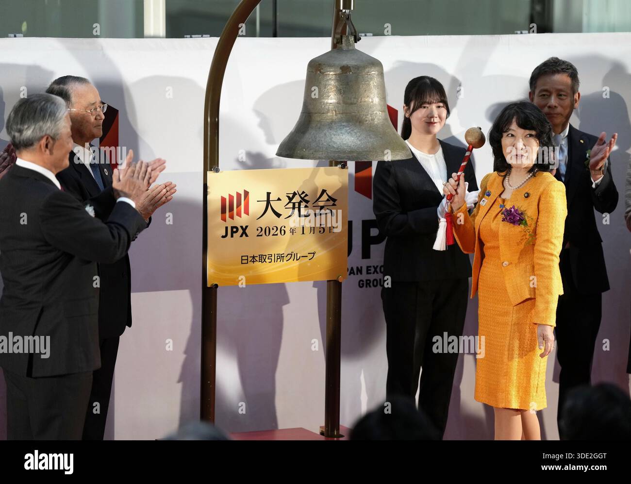 Japanese Finance Minister Satsuki Katayama strikes a bell at a ceremony ...