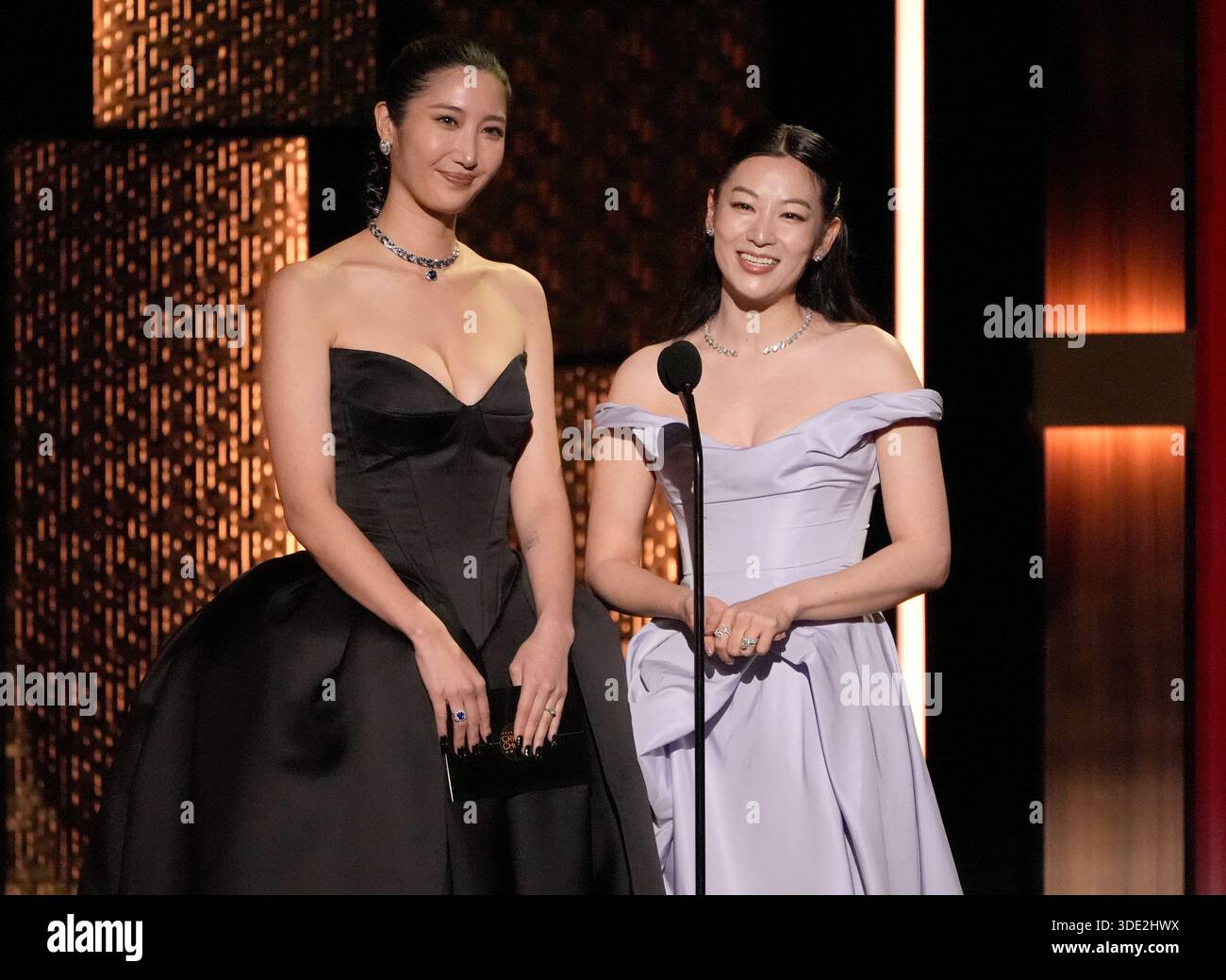 EJAE, left, and Arden Cho present the award for best supporting actress ...