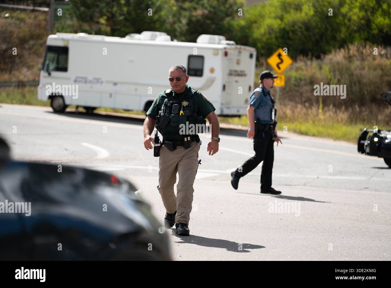 Police officers and sheriffs deputies swarm the area around Evergreen ...