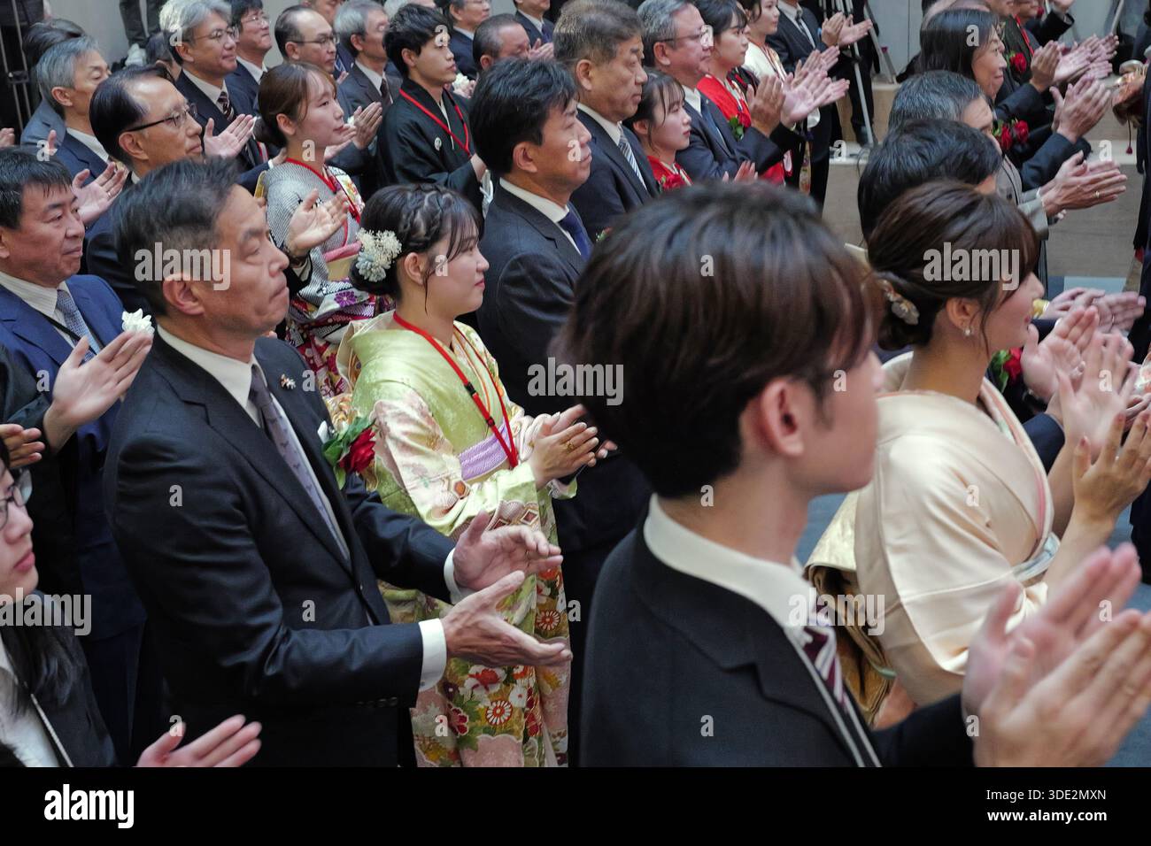 Staff of the Tokyo Stock Exchange and guests make a ceremonial hand ...