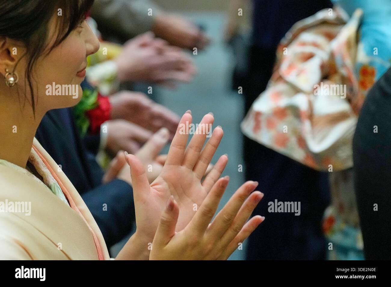 A guest makes a ceremonial hand-clapping during a ceremony marking the ...