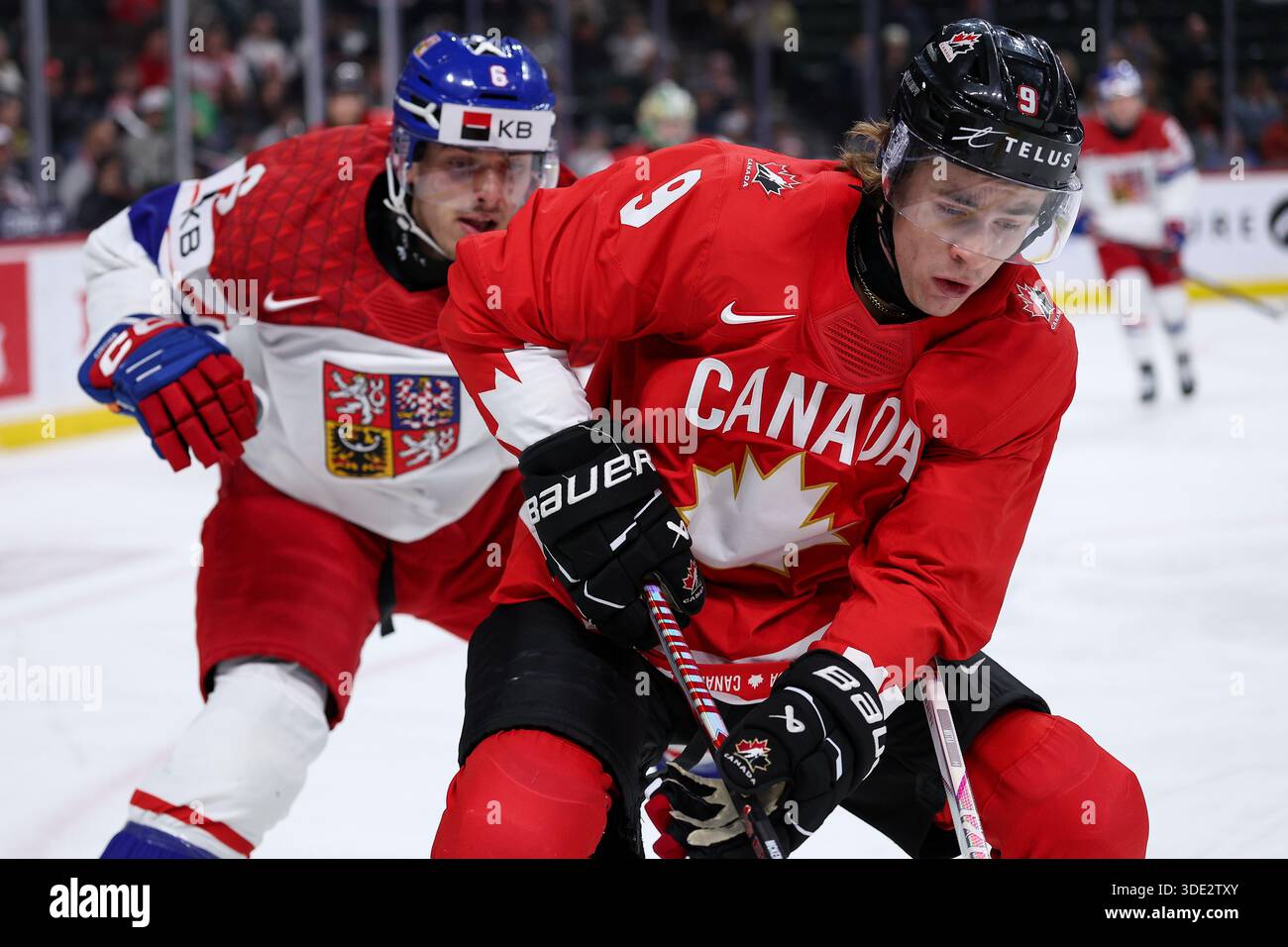 Canada forward Gavin McKenna, right, skates with the puck as Czechia ...