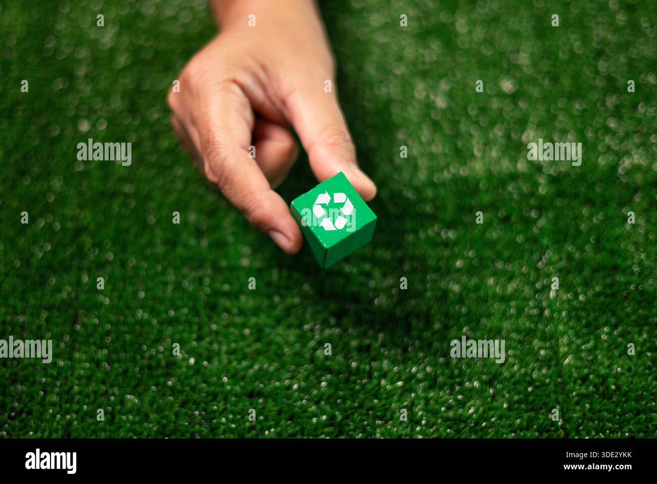 Wooden cube featuring a green net design represents sustainable ...
