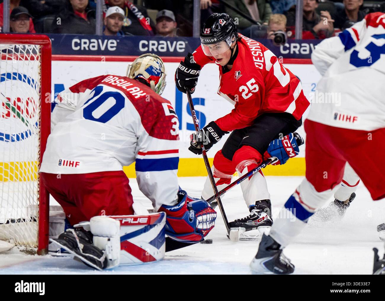 Canada's Caleb Desnoyers (25) shoots on Czechia goaltender Michal ...