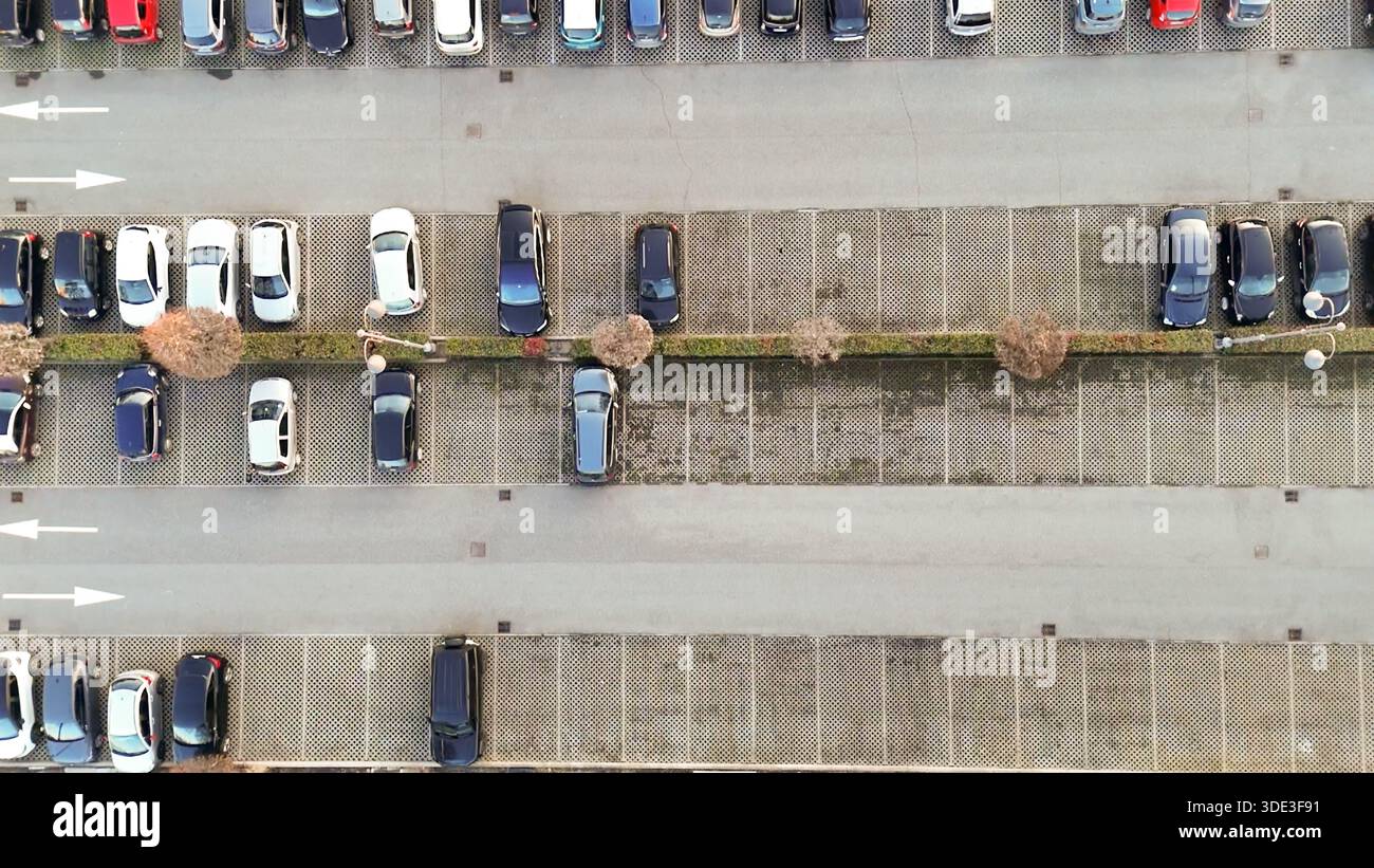 An overhead perspective captures a sprawling parking area with numerous ...
