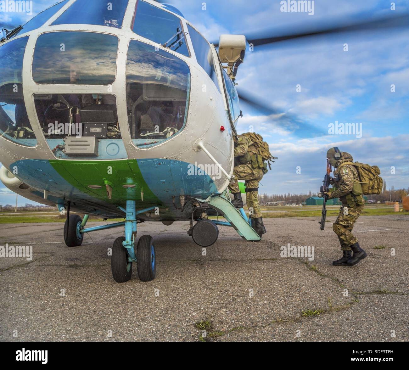 Special Forces soldiers are loaded into the helicopter with the engine ...
