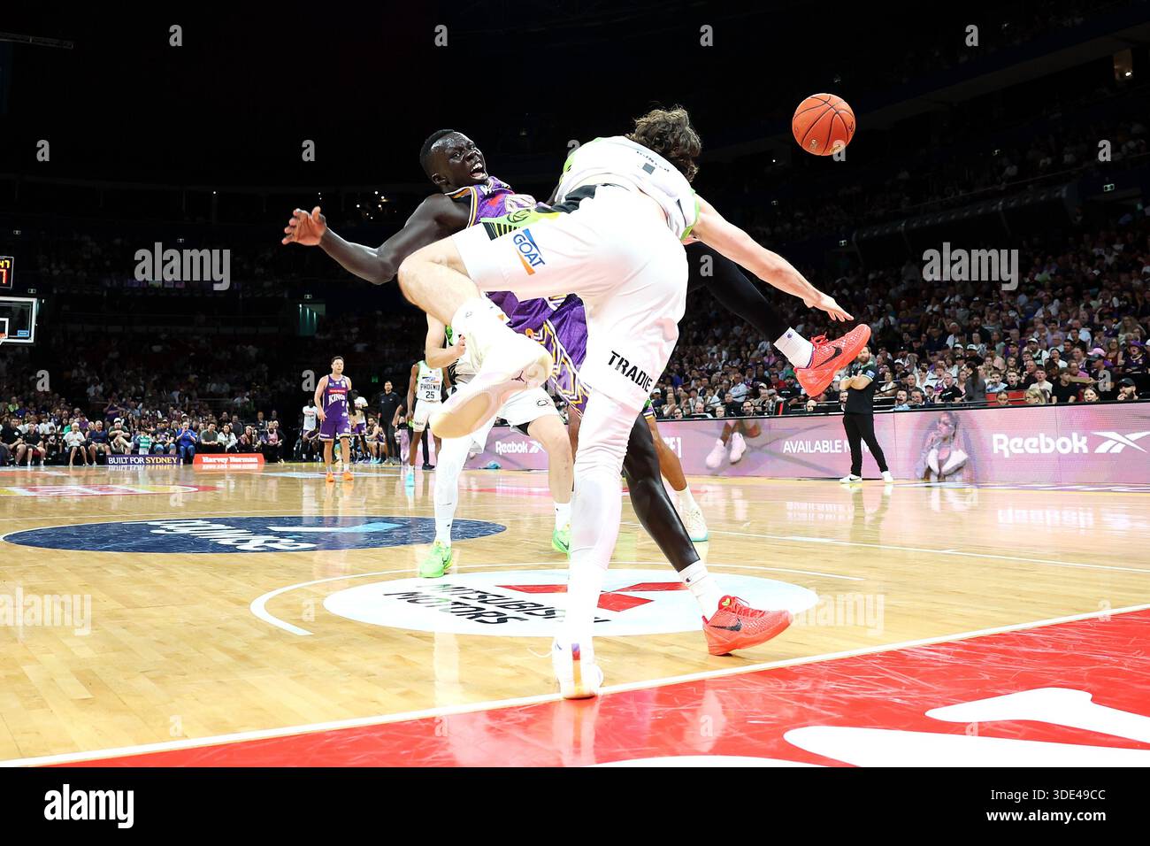 Makuach Maluach of the Kings falls after dunking as Jordan Hunter of ...