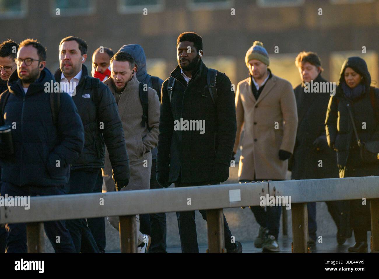 05/01/2026. London, UK. Commuters walk across London Bridge during the ...