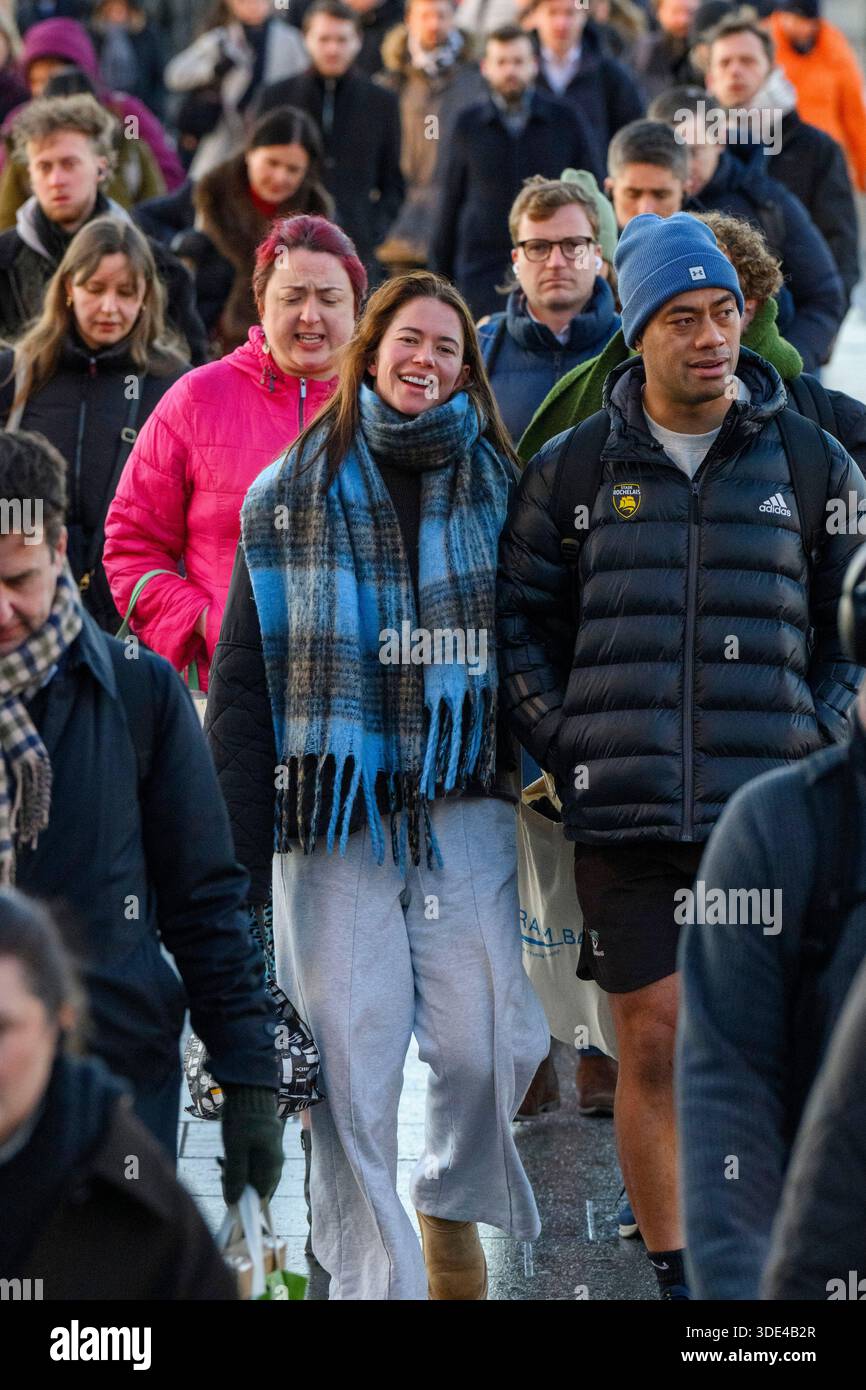 05/01/2026. London, UK. Commuters walk across London Bridge during the ...
