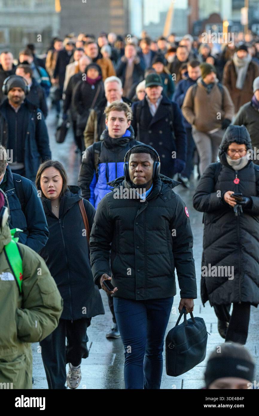 05/01/2026. London, UK. Commuters walk across London Bridge during the ...