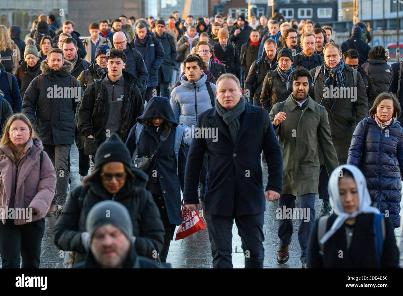 05/01/2026. London, UK. Commuters walk across London Bridge during the ...