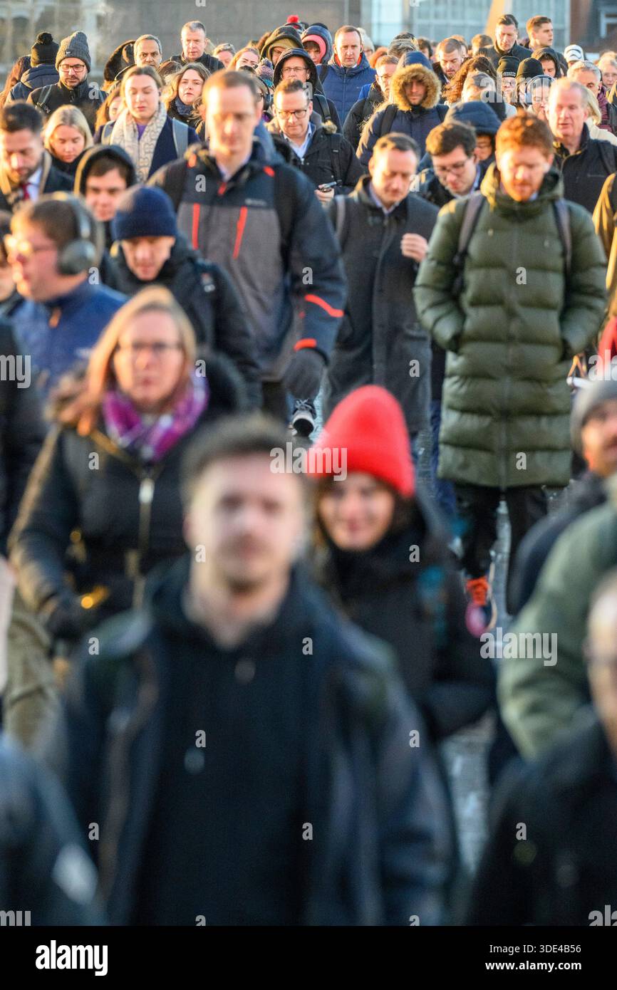 05/01/2026. London, UK. Commuters walk across London Bridge during the ...