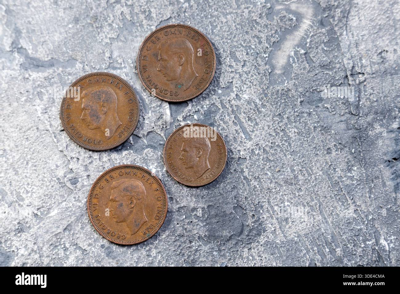 Three George VI half pennies and a farthing one quarter of a penny from ...