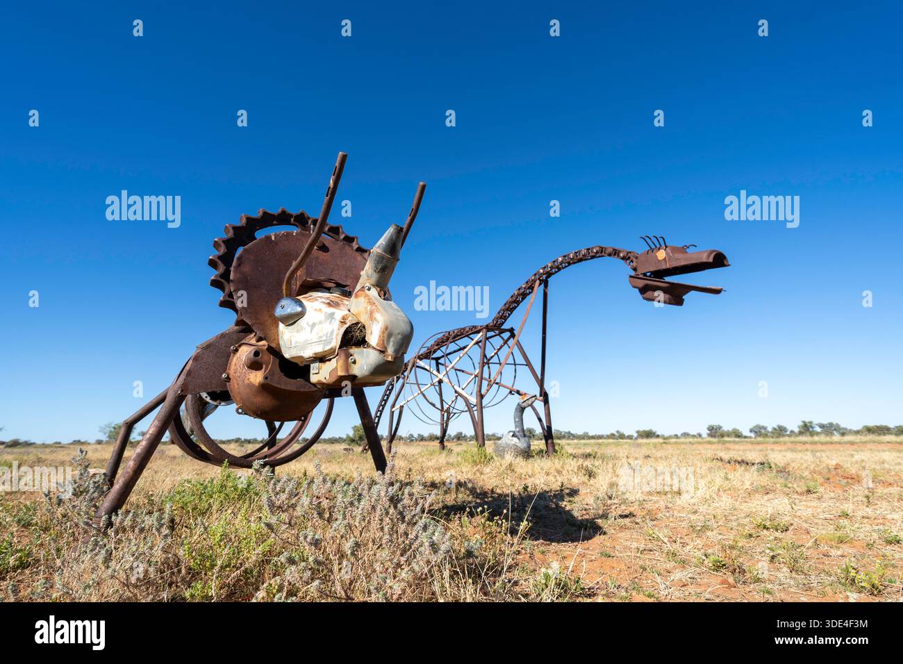 Dinosaur sculpture made from scrap metal in field on outskirts of ...