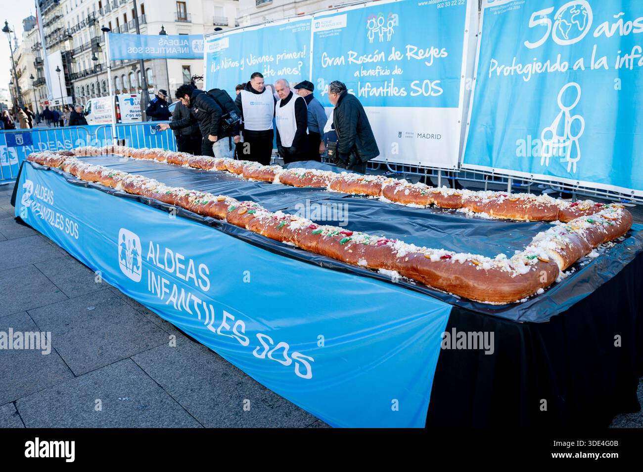 Volunteers during the distribution at Puerta del Sol of the traditional ...