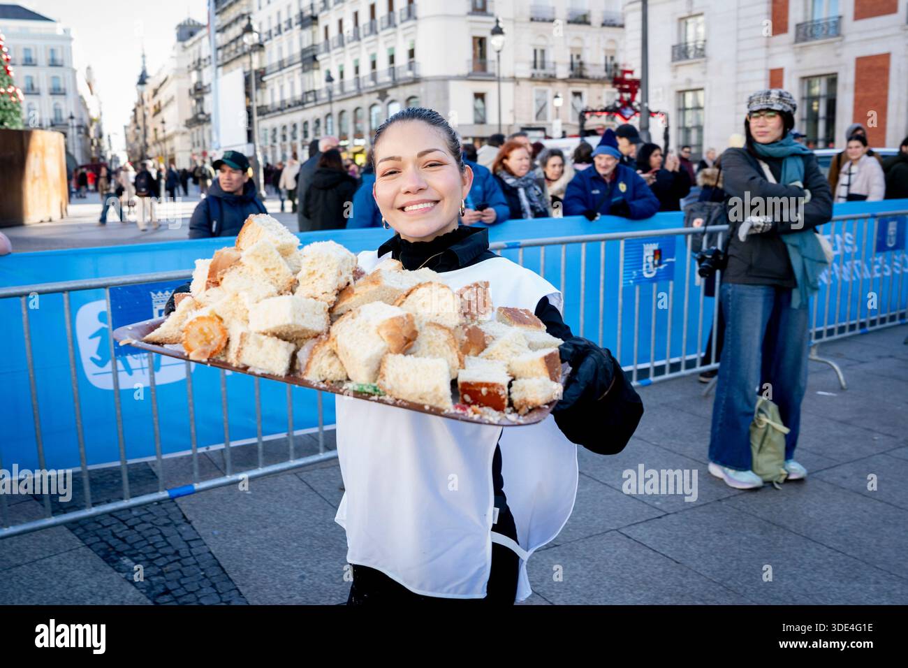 Volunteers during the distribution at Puerta del Sol of the traditional ...