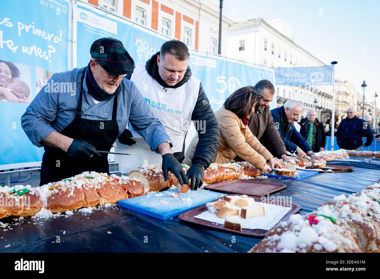 Volunteers during the distribution at Puerta del Sol of the traditional ...