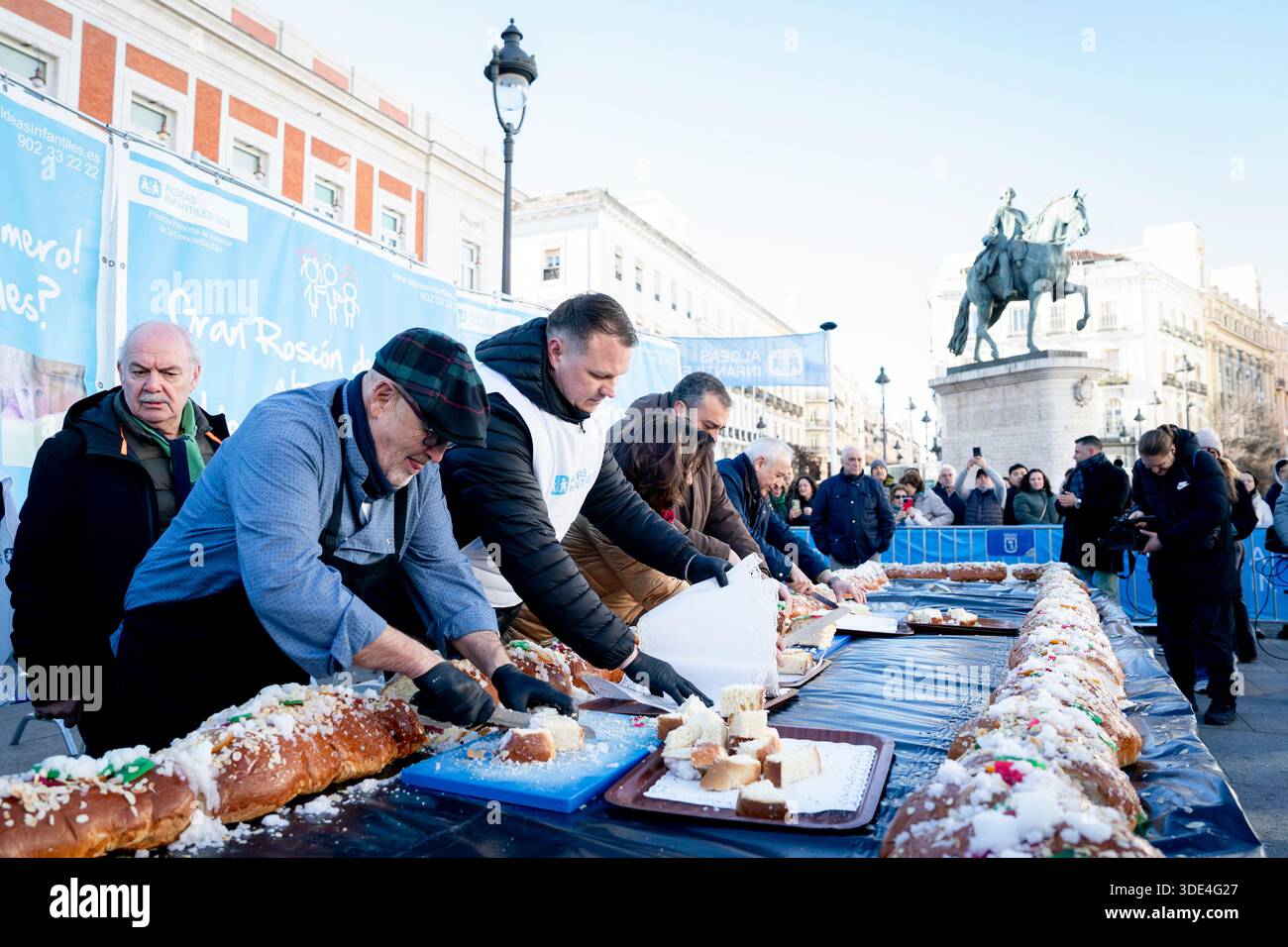 Volunteers during the distribution at Puerta del Sol of the traditional ...