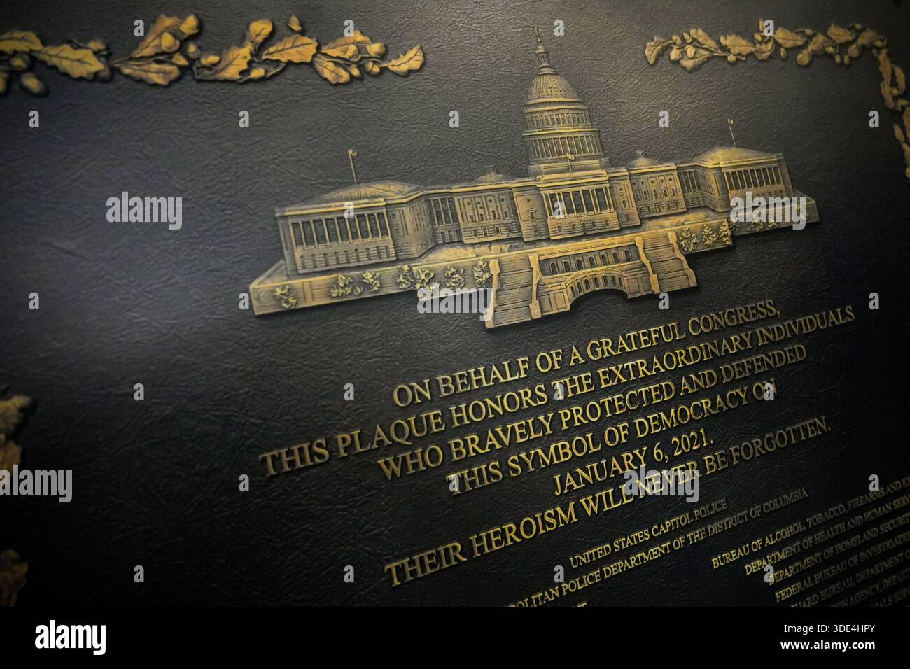 A replica plaque commemorating the Jan. 6, 2021 Capitol riot stands ...